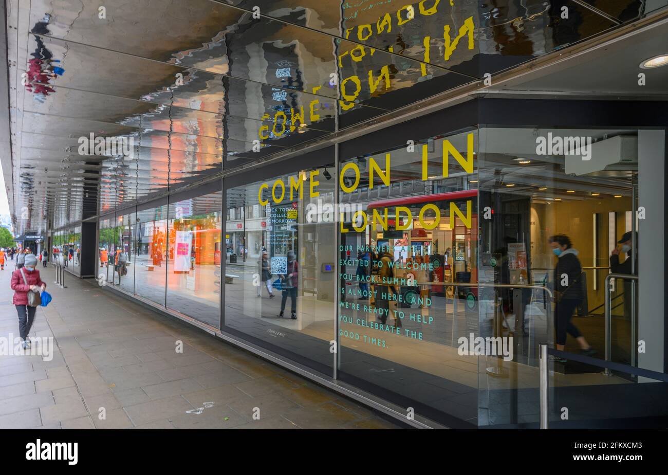 Pedestrian walks under the canopy of John Lewis flagship store in ...