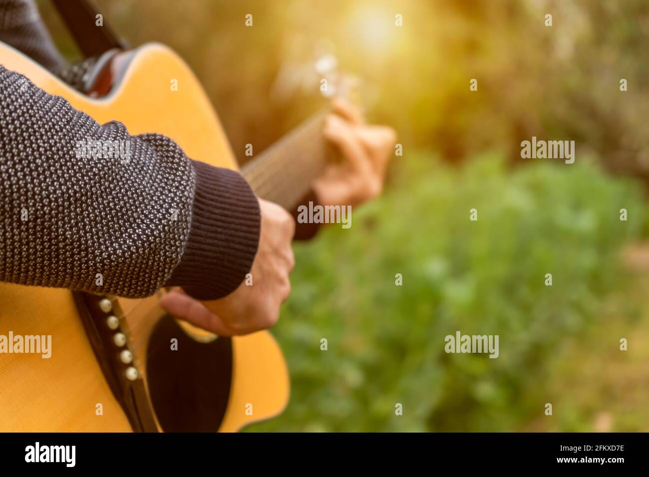 Guy playing guitar in nature hi-res stock photography and images - Alamy
