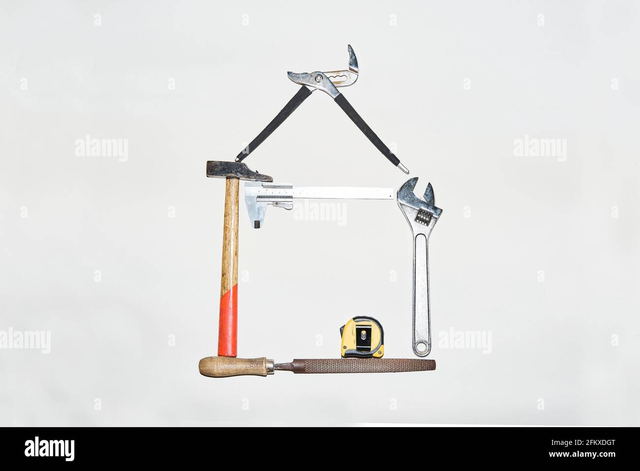 Set of do-it-yourself tools in the shape of house on white background ...