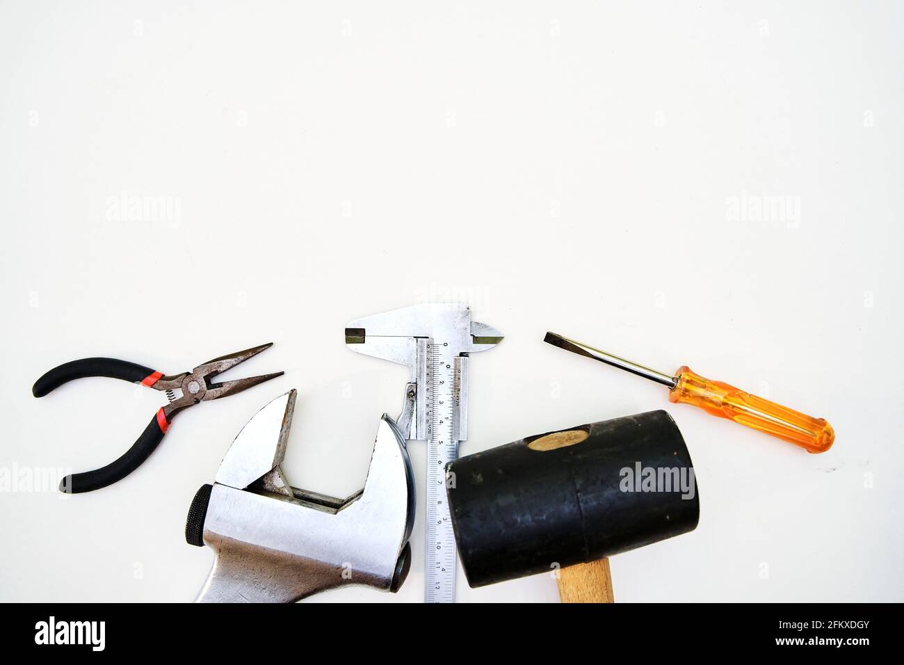 Group of do-it-yourself hand tools consisting of rubber hammer, pliers ...
