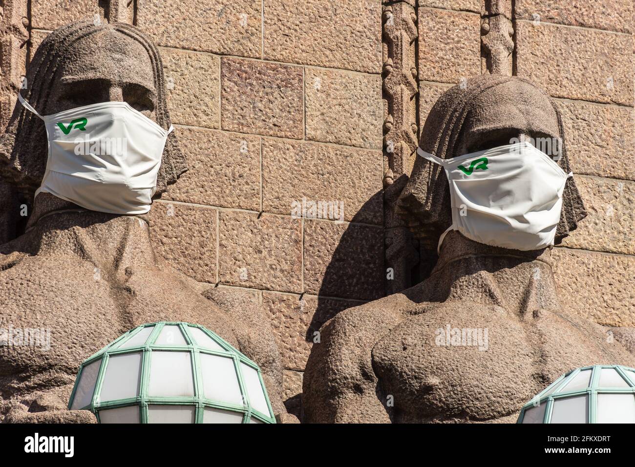 Lantern carrier statues by Emil Wikström with a mask on the Railway ...