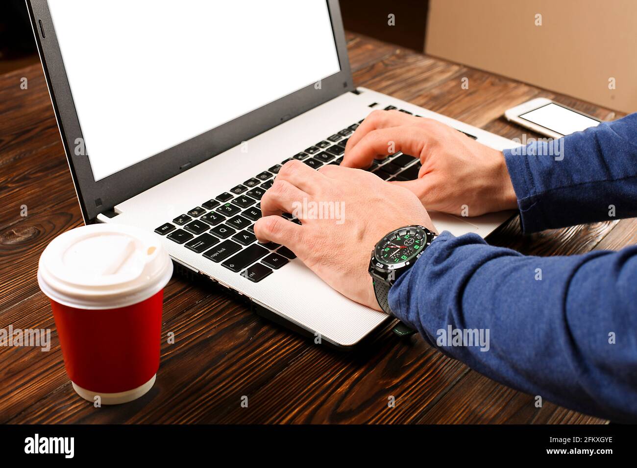 Close up of male hands wearing wrist watch typing on pc laptop computer ...