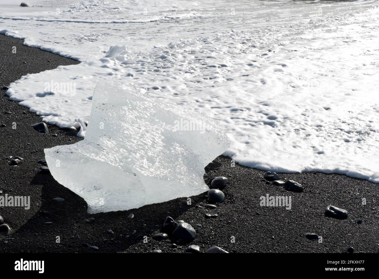 Very clear ice from glaciers floats through the Jokulsarlon lagoon onto ...