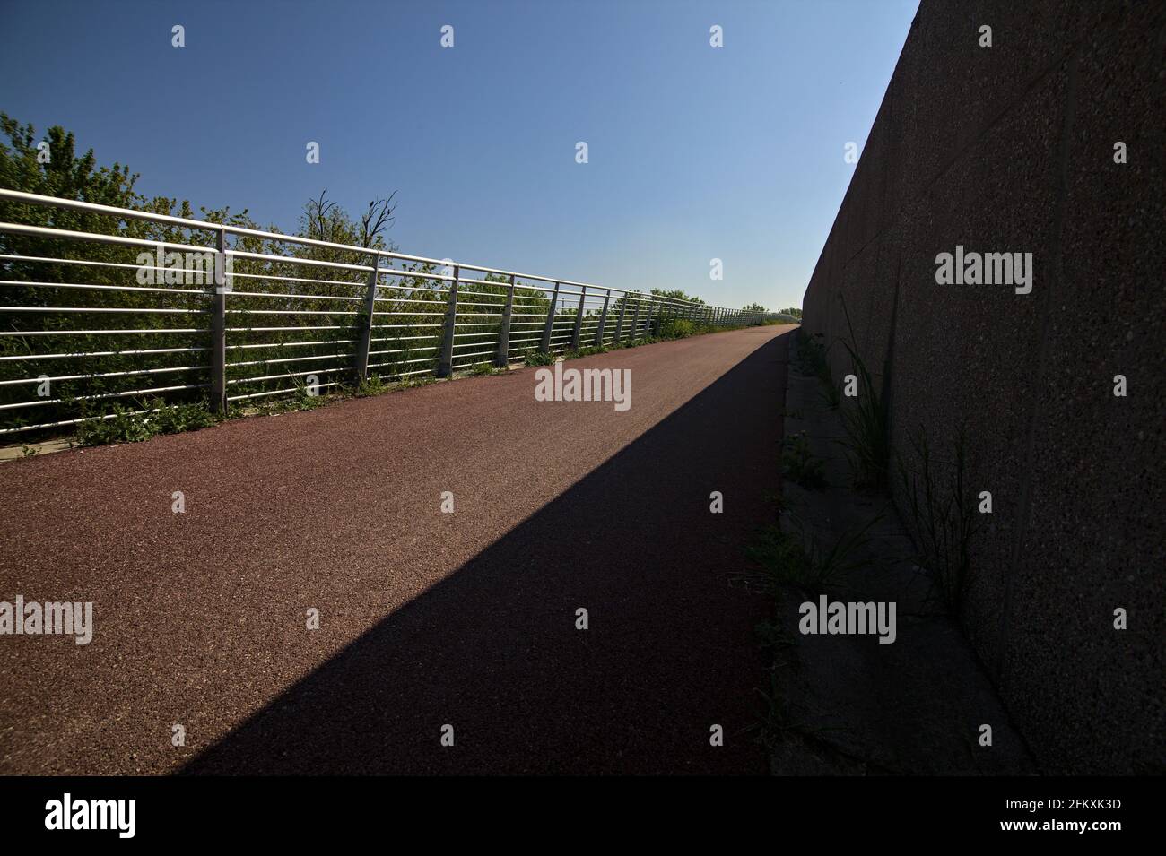 Bike path made of red concrete on a clear day in spring Stock Photo - Alamy