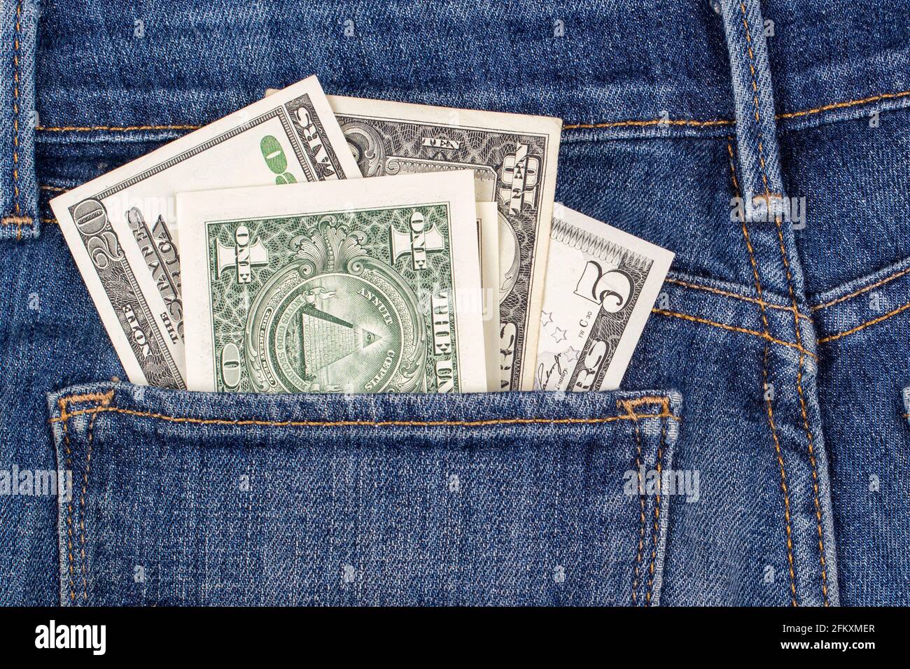 American dollars banknotes peeking out of blue jeans back pocket. Money ...