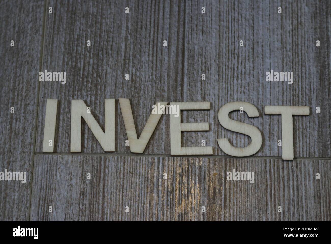 The word invest wrote on tiles theme Stock Photo - Alamy