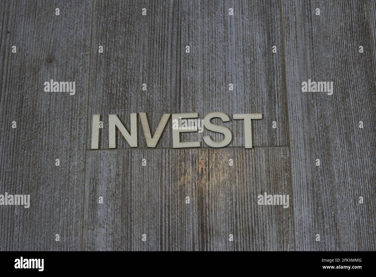 The word invest wrote on tiles theme Stock Photo - Alamy