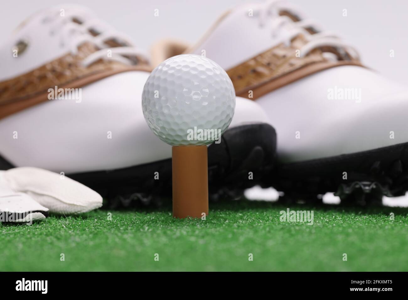 Golf boots, gloves and ball stand on green lawn Stock Photo - Alamy