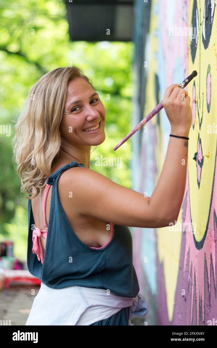 Side view of female artist smiling Stock Photo - Alamy