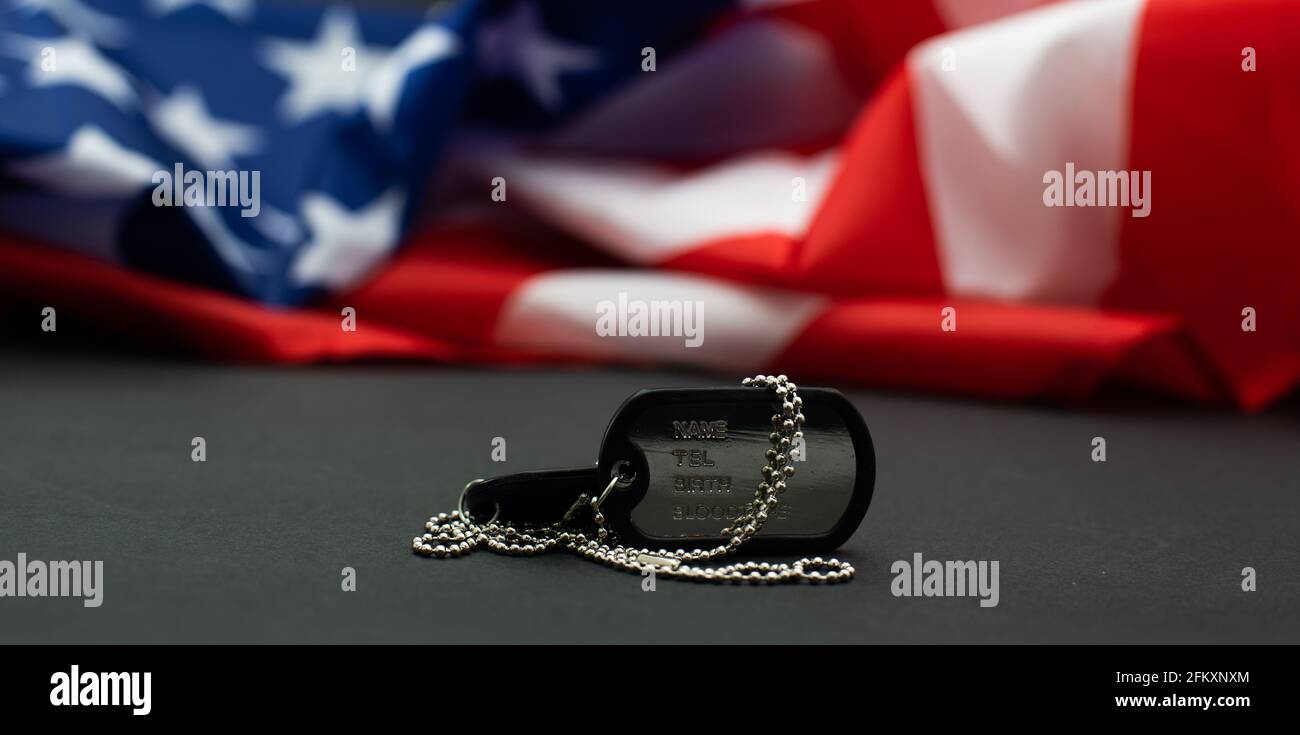 Army tokens on American national flag background Stock Photo - Alamy