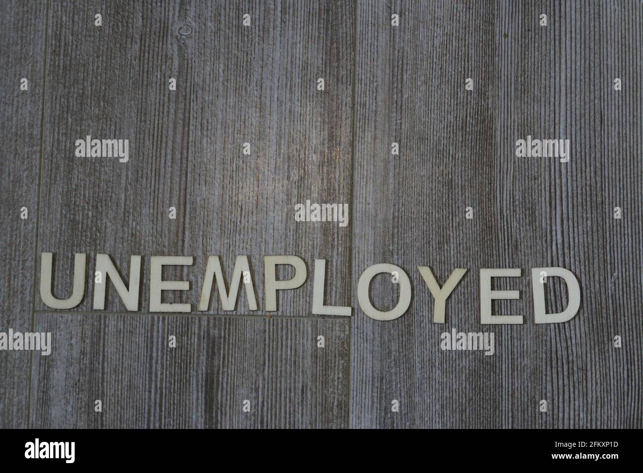 the word unemployed in a flat lay concept Stock Photo - Alamy