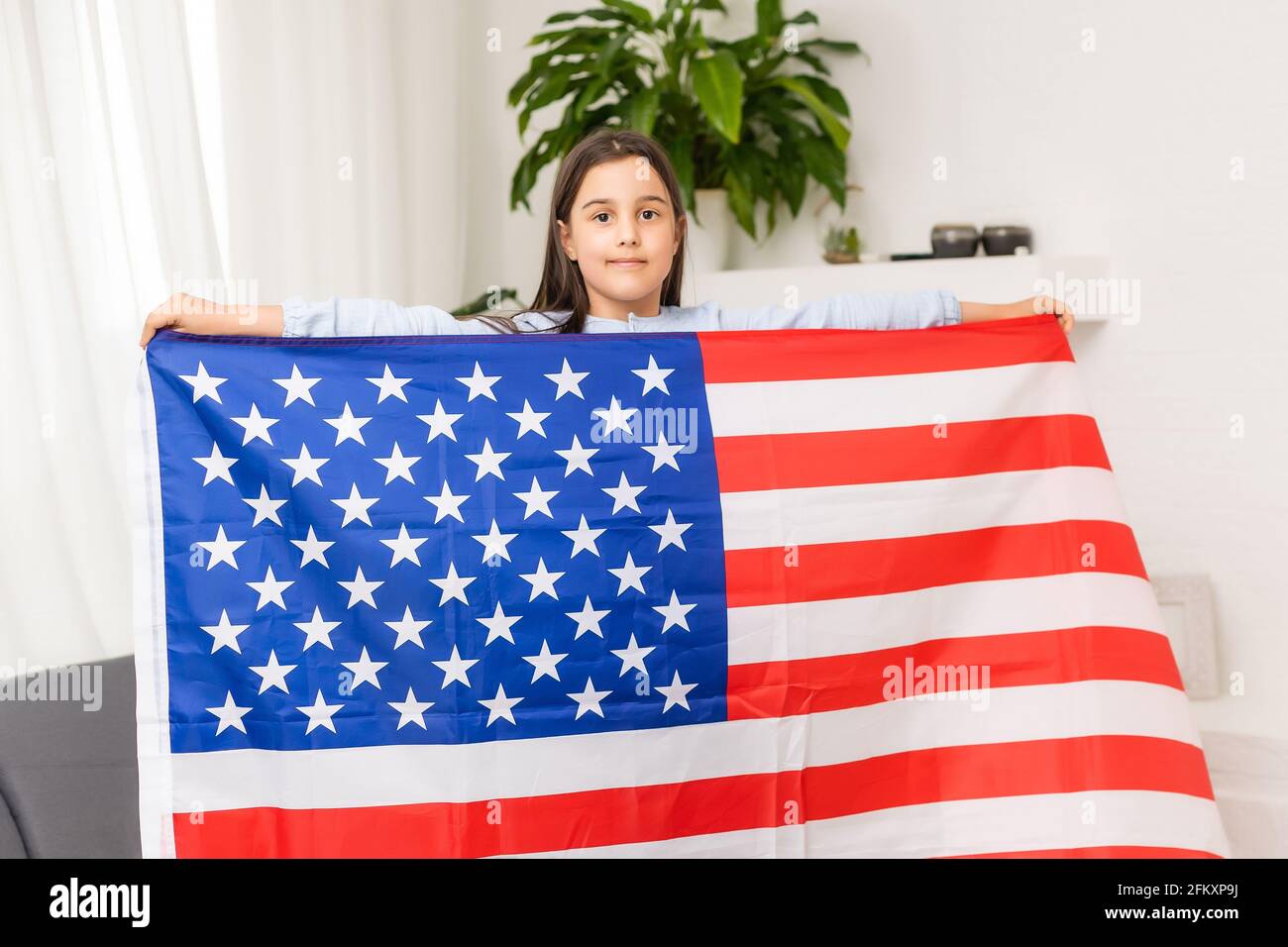 Cute little girl and USA flag on background Stock Photo - Alamy