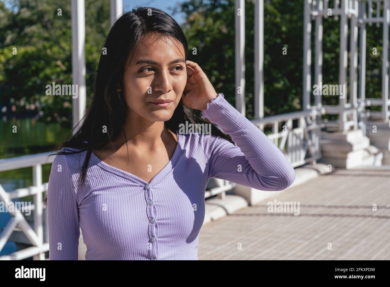 Beautiful woman fixing hair hi-res stock photography and images - Alamy