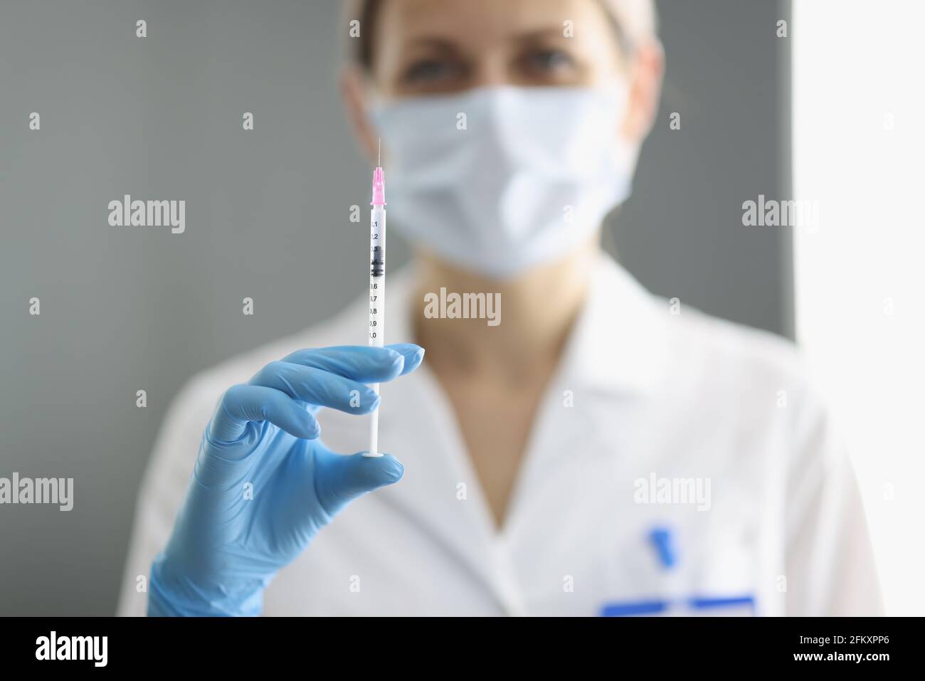 Portrait of doctor in whose hand medical syringe with needle Stock ...