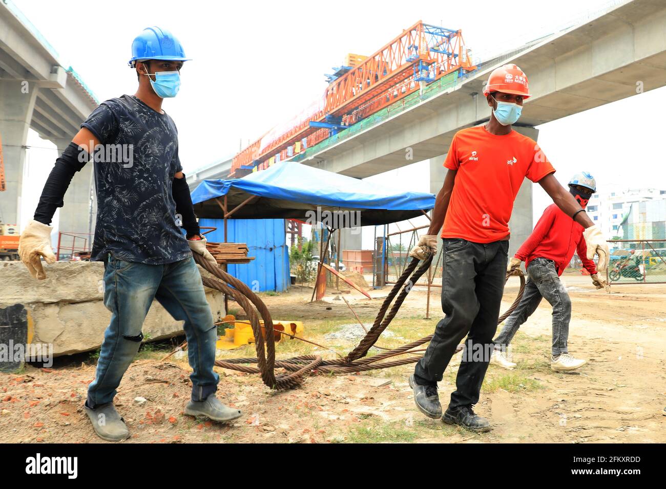Workers seen working on the Padma bridge.The Planning Commission is ...