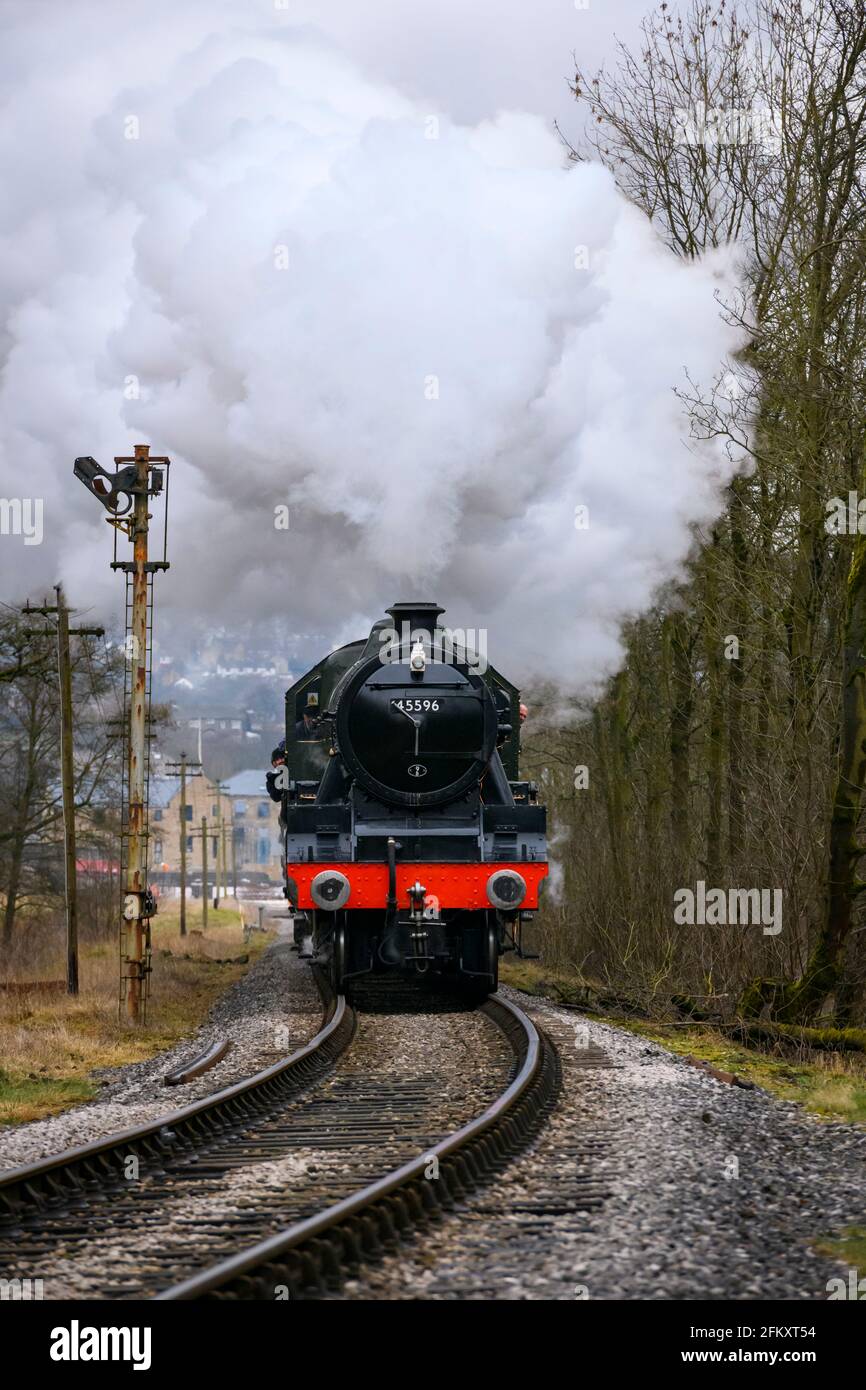 Historic steam train (loco) puffing smoke clouds, travelling on scenic ...