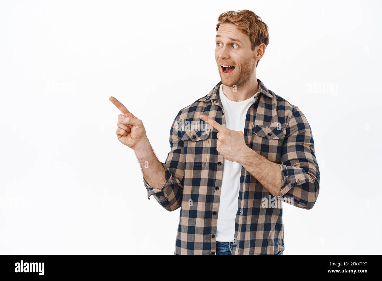 Hey look at this banner. Smiling handsome redhead guy pointing and ...