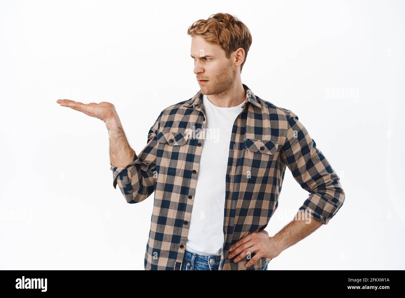 Angry disappointed male customer looking at his open hand holding ...