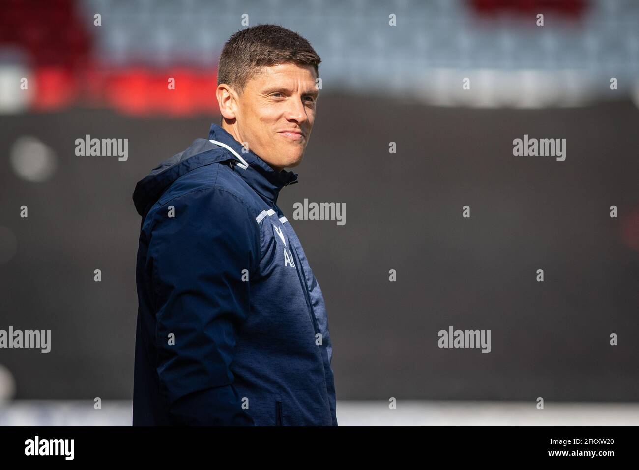 Alex Revell standing on touchline in the sun during game at Lamex ...