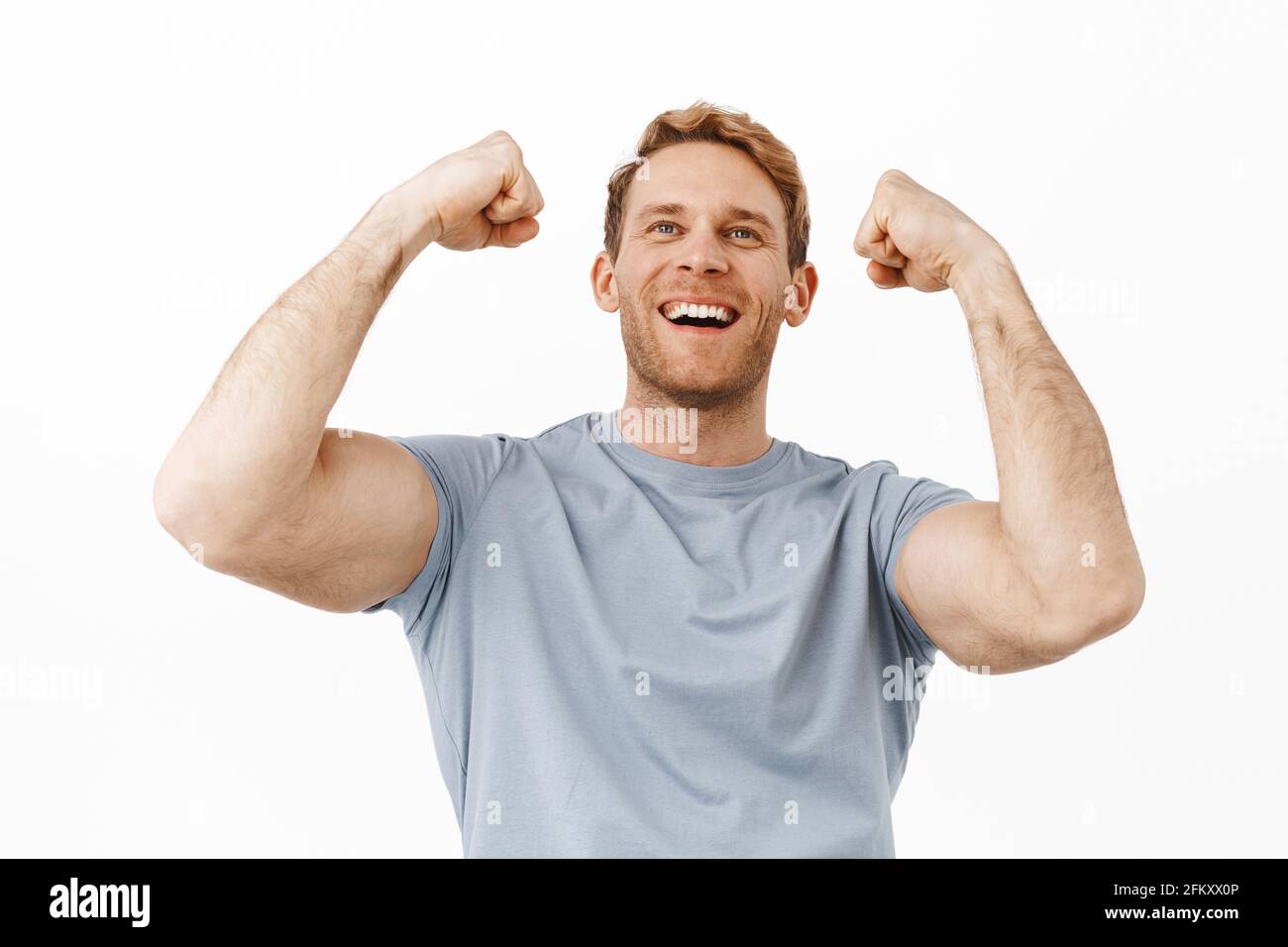 Strong and handsome redhead man with perfect body, raising masculine ...