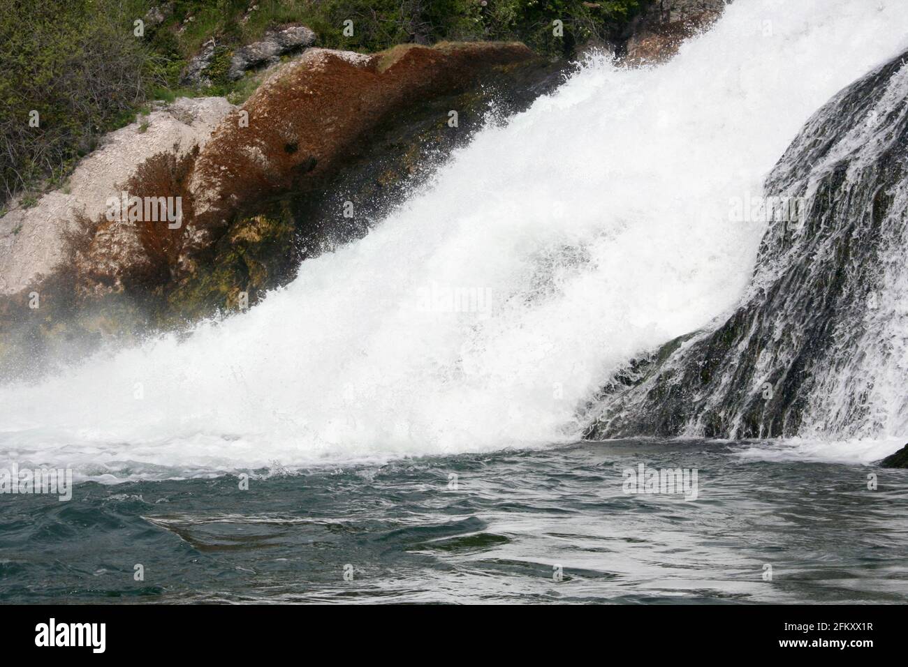 a waterfall with white, foaming in spray Stock Photo - Alamy