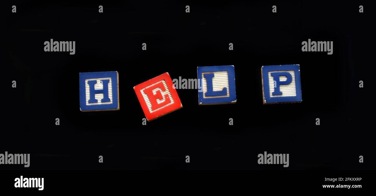 Wooden block letters spell the word help on a back background Stock ...