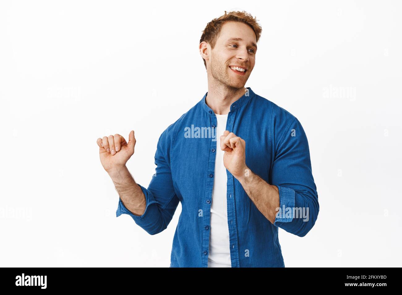 Handsome stylish redhead guy dancing, having fun and smiling, relaxing ...