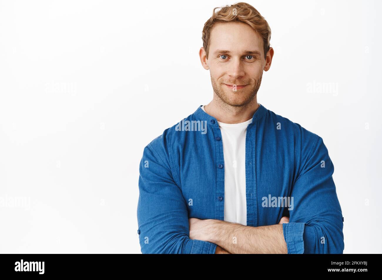 Close up of handsome professional man, cross arms on chest and looking ...