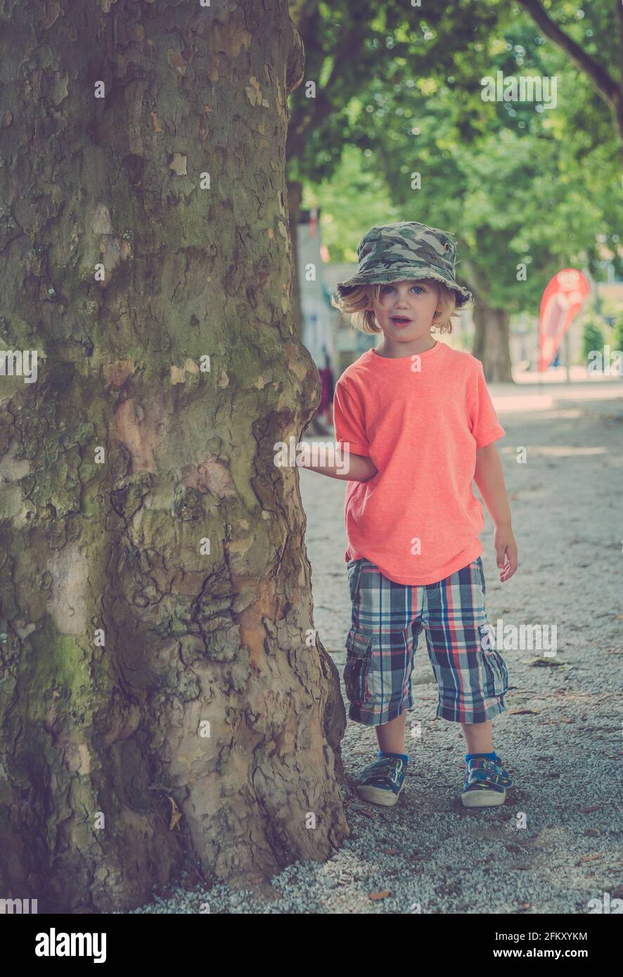 Children standing under a tree hi-res stock photography and images - Alamy