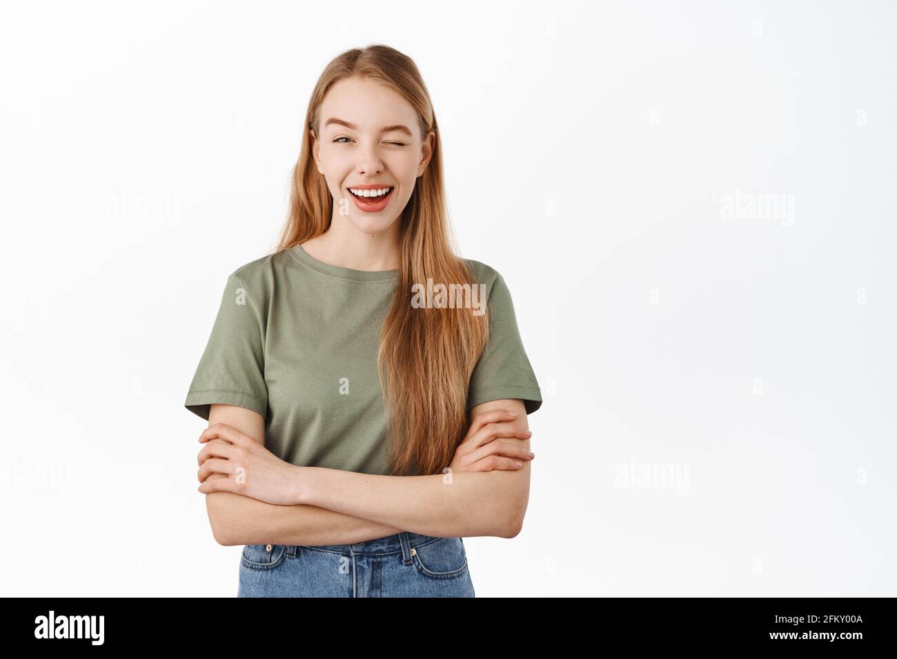 Happy blond girl winking and smiling, give you hint, encourage ...