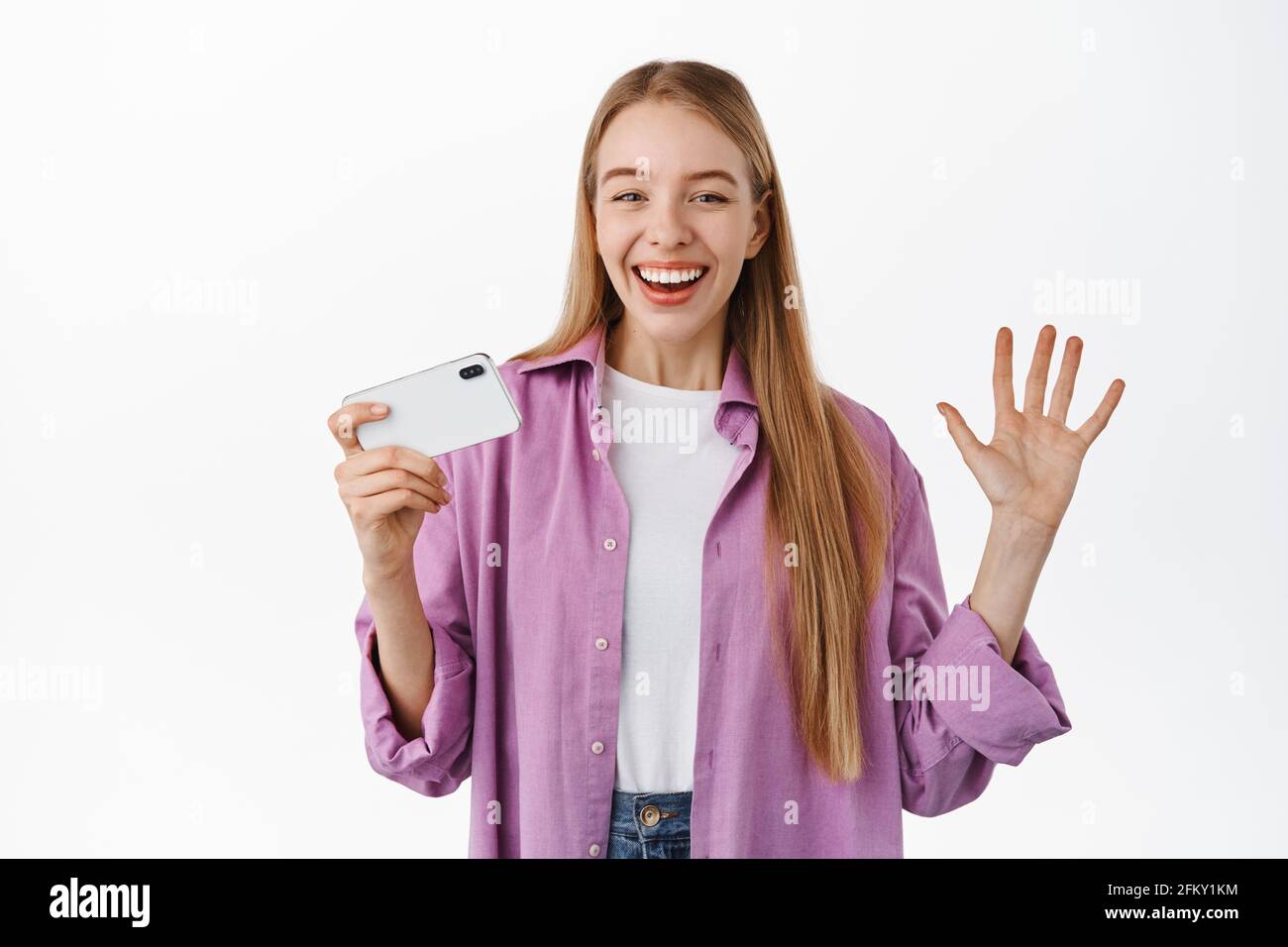 Excited smiling girl winning on mobile phone, showing five fingers ...