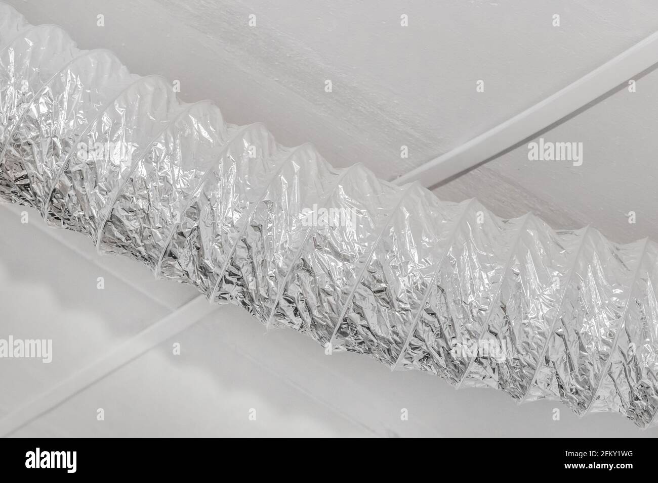 Ventilation air metal pipe under ceiling at an industrial plant or ...
