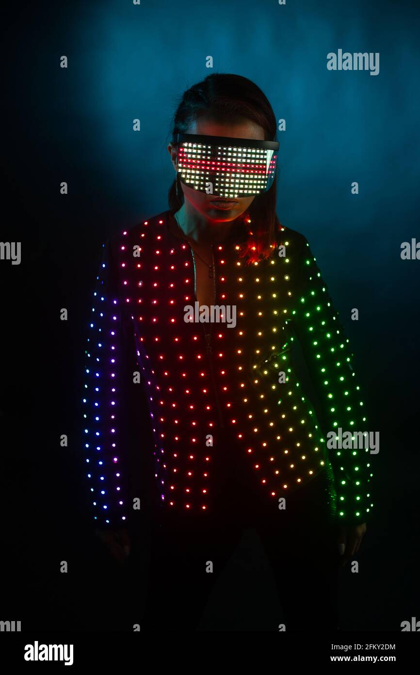 Girl in LED suit on a black background Stock Photo - Alamy