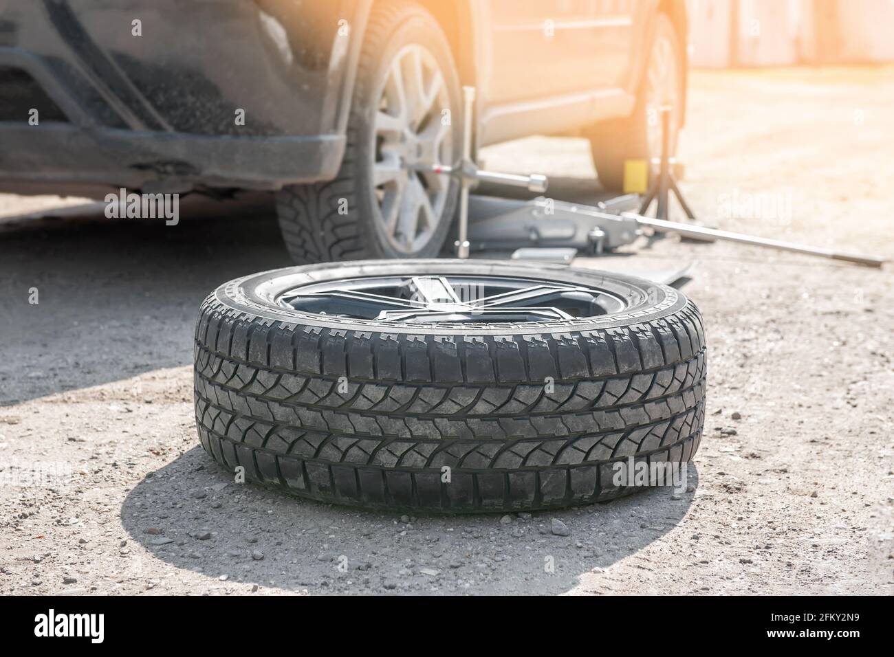 Replacing the wheel on the road by the driver. Replacement of tires on ...