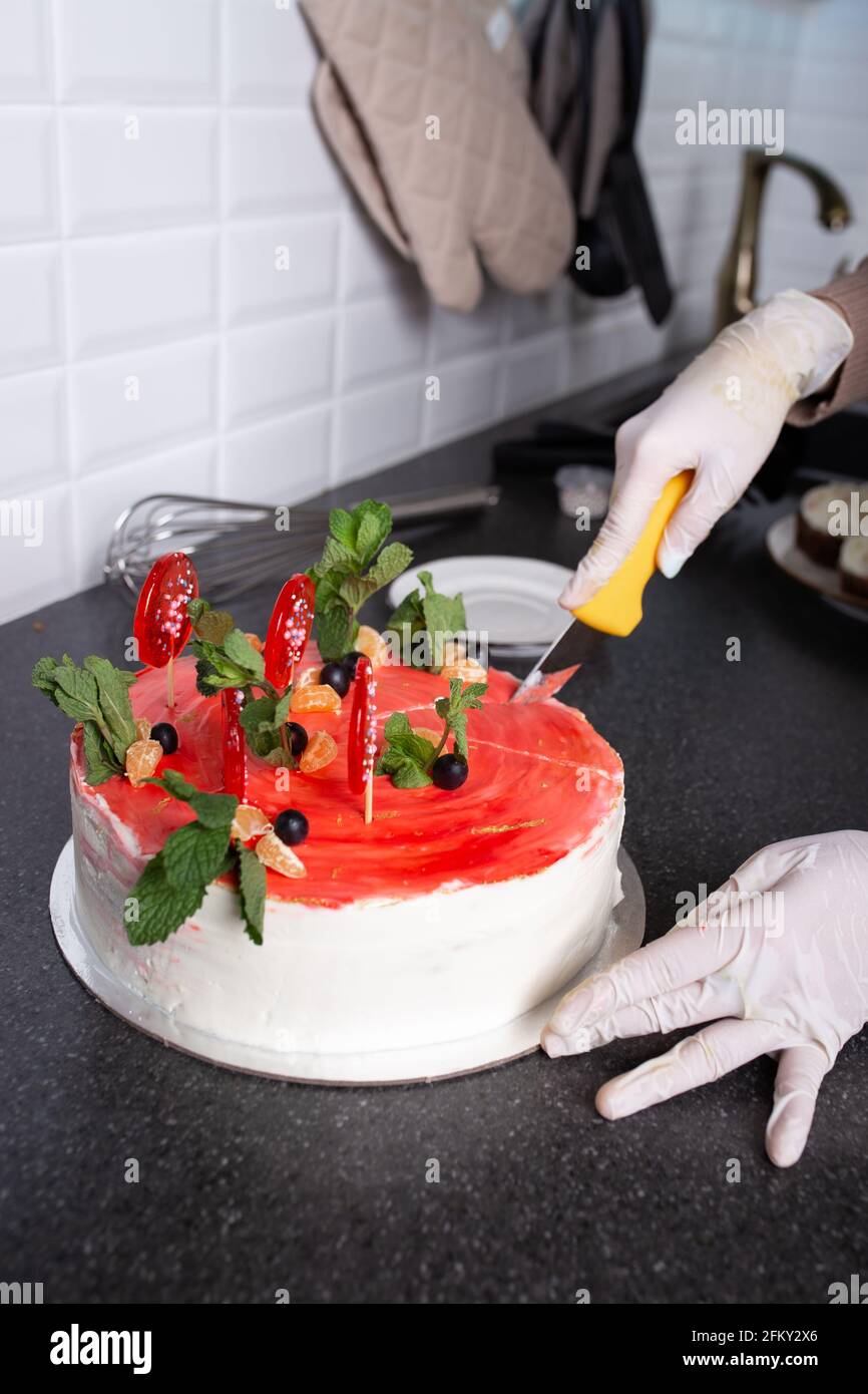 cut the cake with a knife on the work surface Stock Photo - Alamy