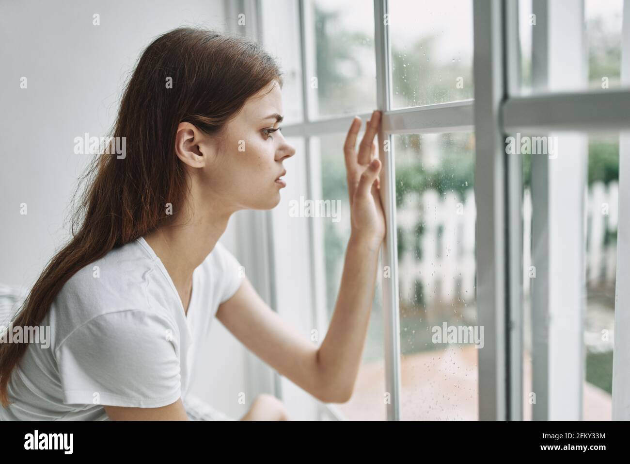 woman looking out the window pensive look emotions sadness Stock Photo ...