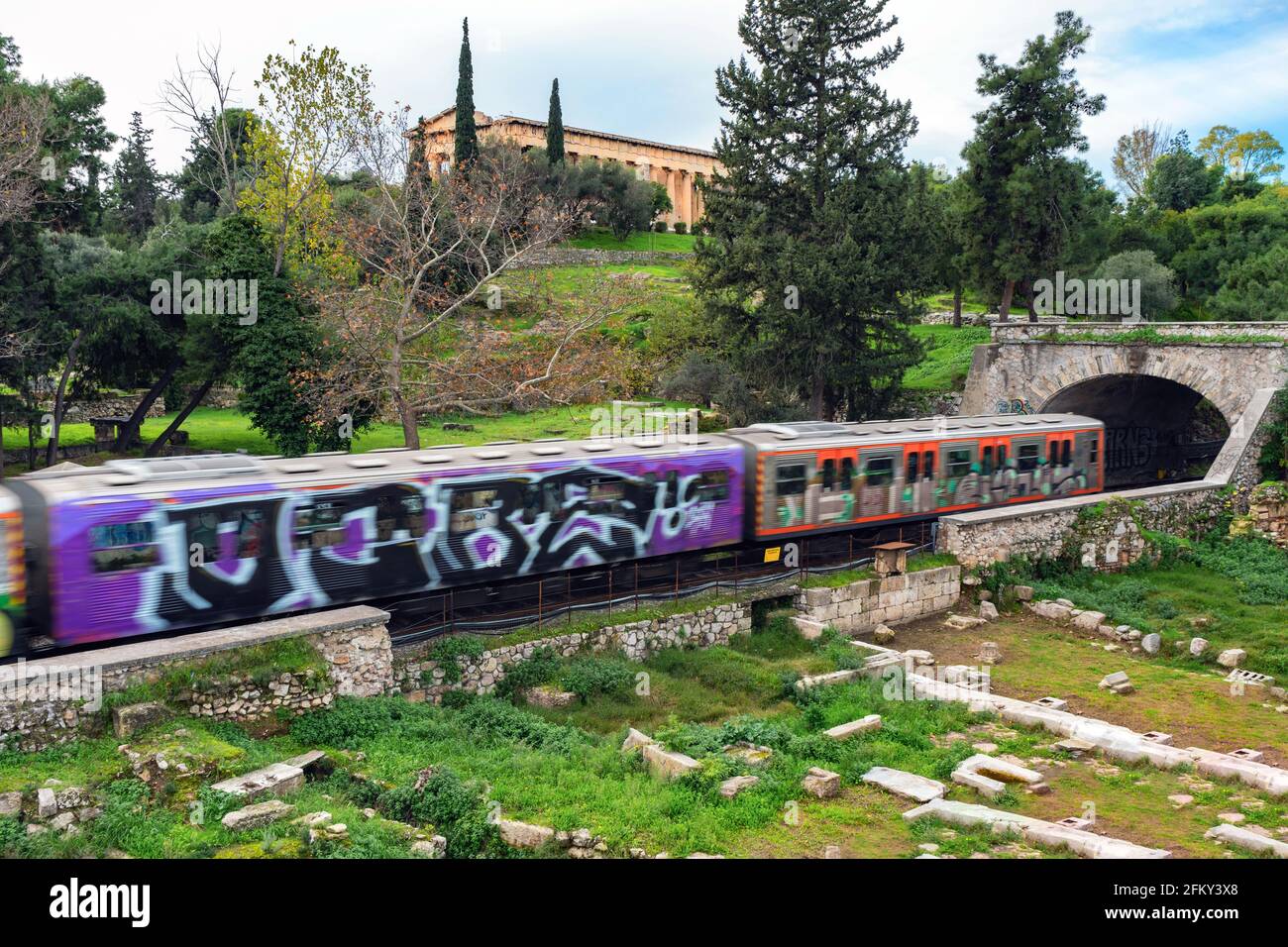 Athens, Greece. The electric train passes under the stone bridge in ...