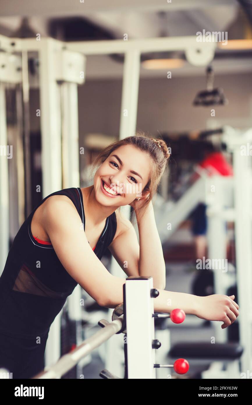 Positive sporty girl smiles in gym Stock Photo - Alamy