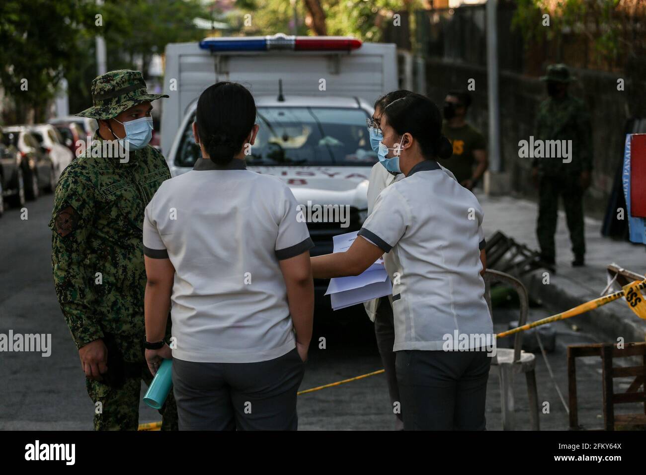 Policemen stop people from entering a checkpoint near a village during ...