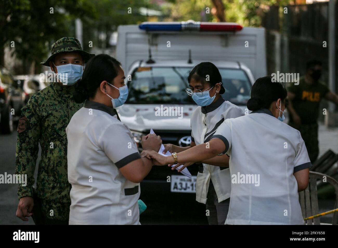 Policemen stop people from entering a checkpoint near a village during ...