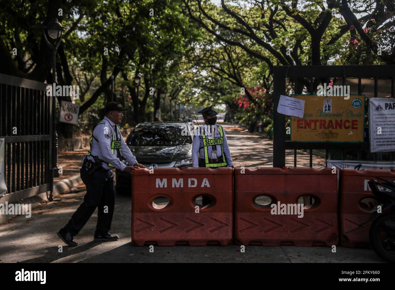 Security officers barricade an entrance at an empty park during a COVID ...