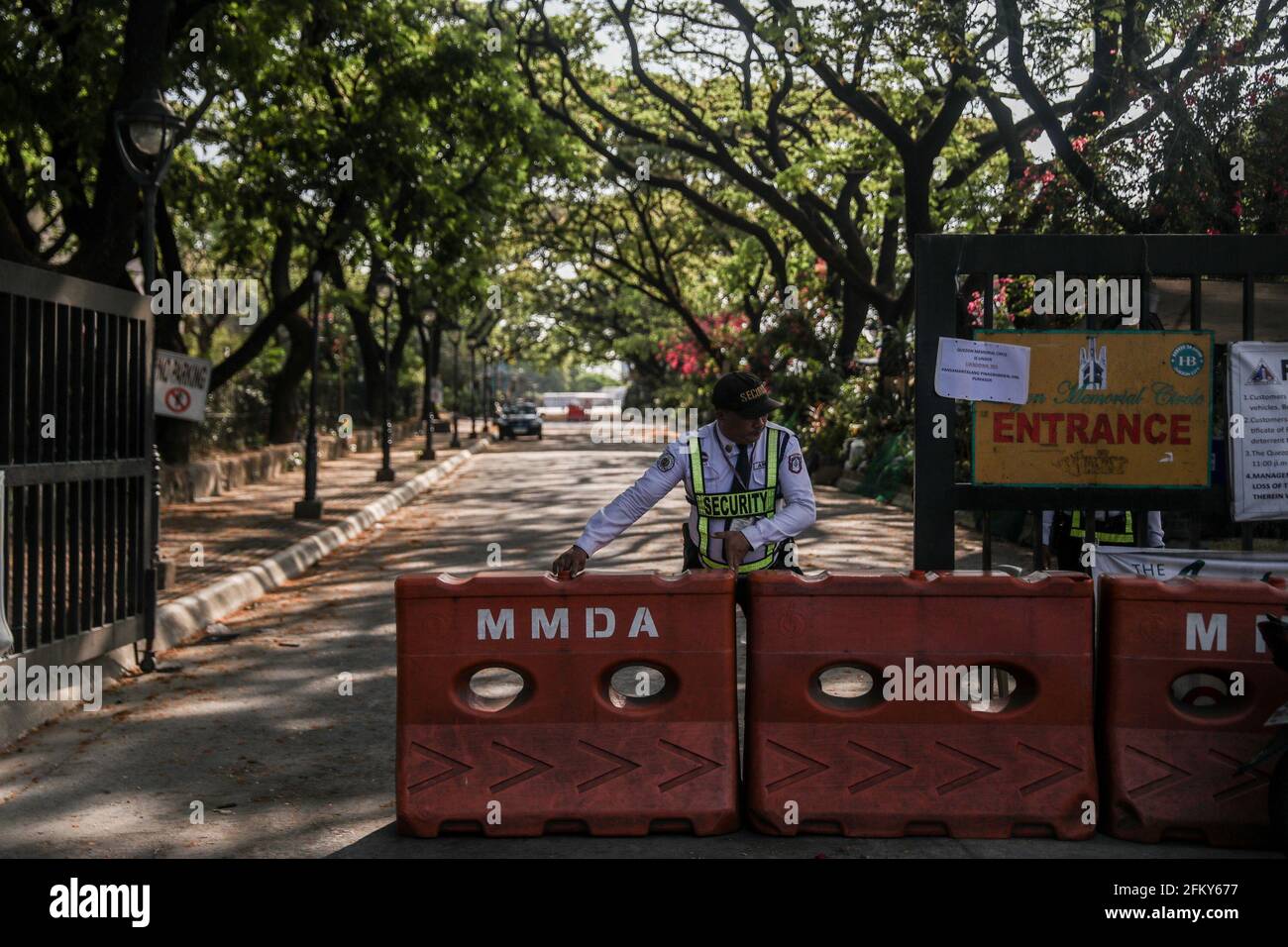 Security officers barricade an entrance at an empty park during a COVID ...