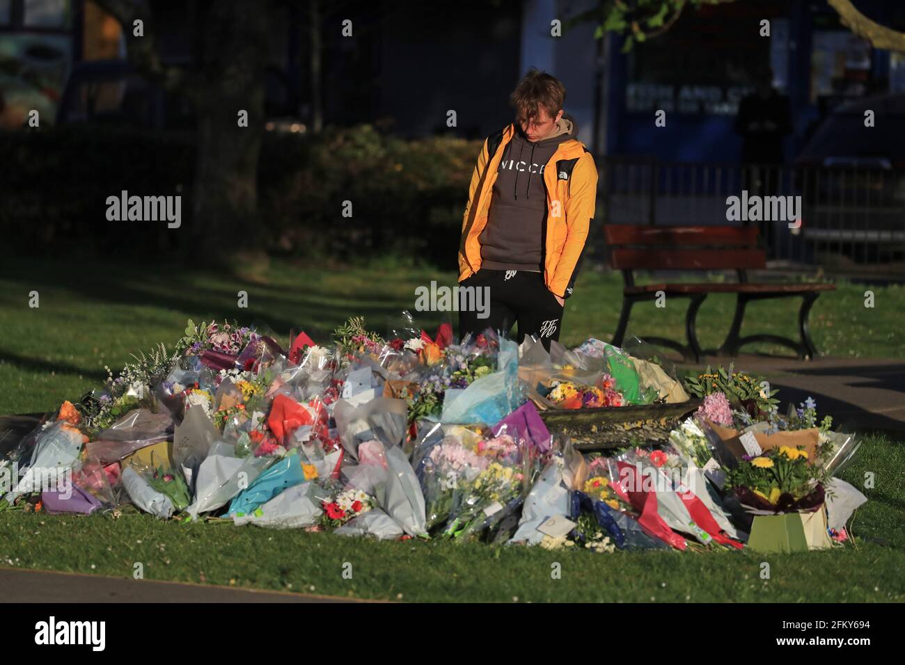 Patrick James, the son of PCSO Julia James, looks at floral tributes ...