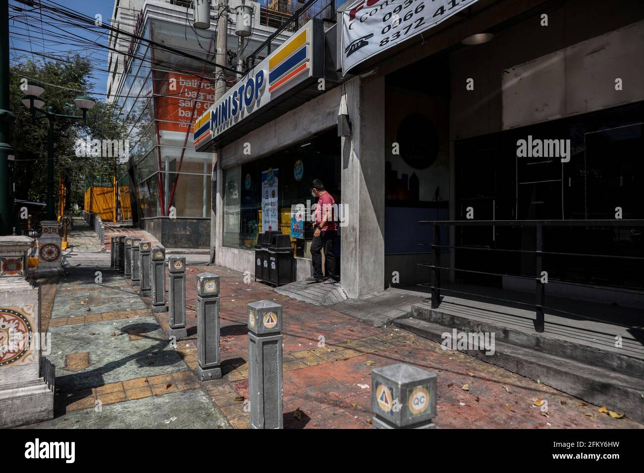 A man walks out a convenience store during a COVID-19 lockdown in ...