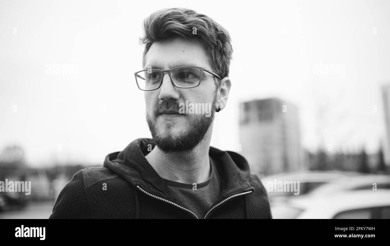 Grayscale portrait of a young Caucasian male wearing glasses Stock ...