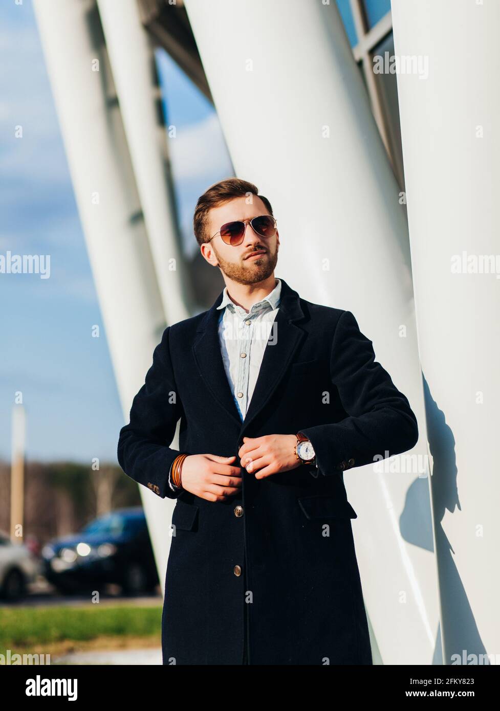 Modern businessman. Confident young man in formal wear and sunglasses ...