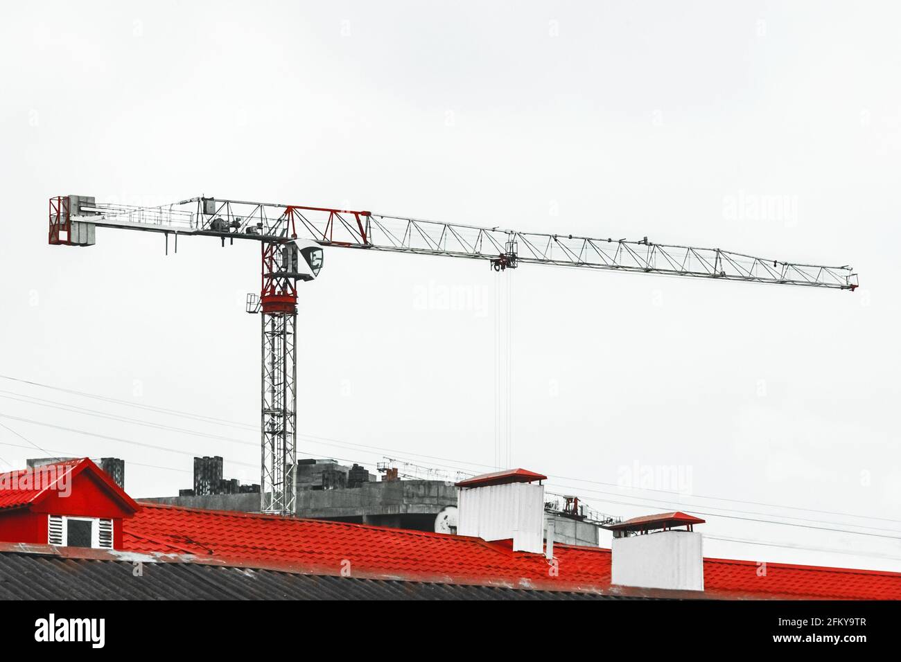 Tower crane against the gray sky builds a new city modern building on ...