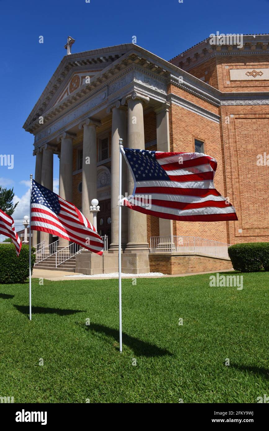 American flags flutter in the breeze in front of the First Baptist ...