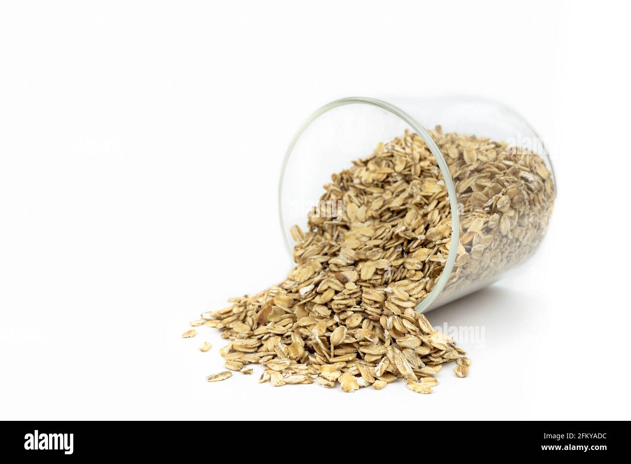 oat grains falling from a glass recipient with white background Stock ...
