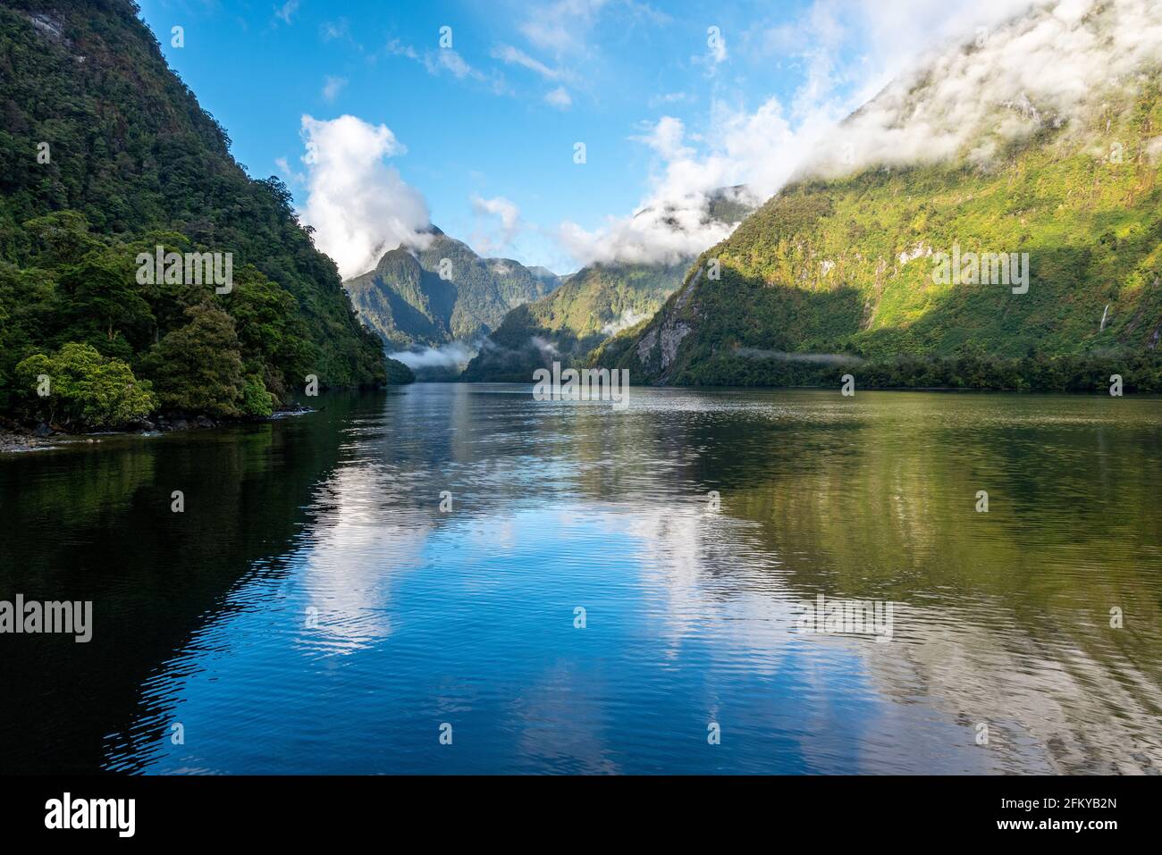 A new morning dawning at Doutful Sound, clouds hanging low in the ...